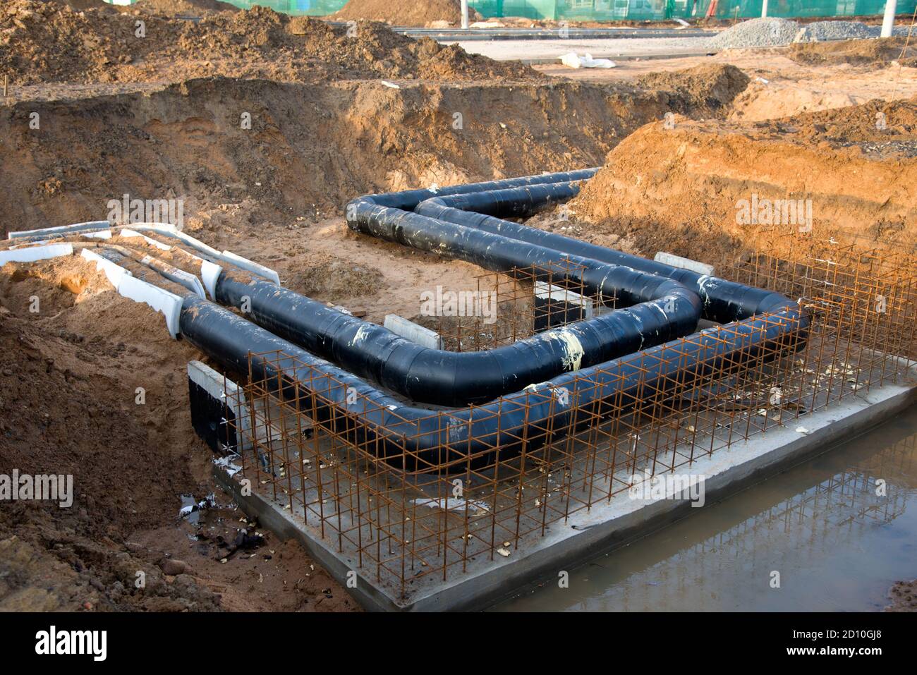 Laying of underground storm sewer pipes in ditch. Installation of water ...