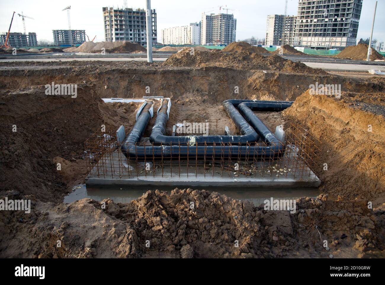 Laying of underground storm sewer pipes in ditch. Installation of water ...