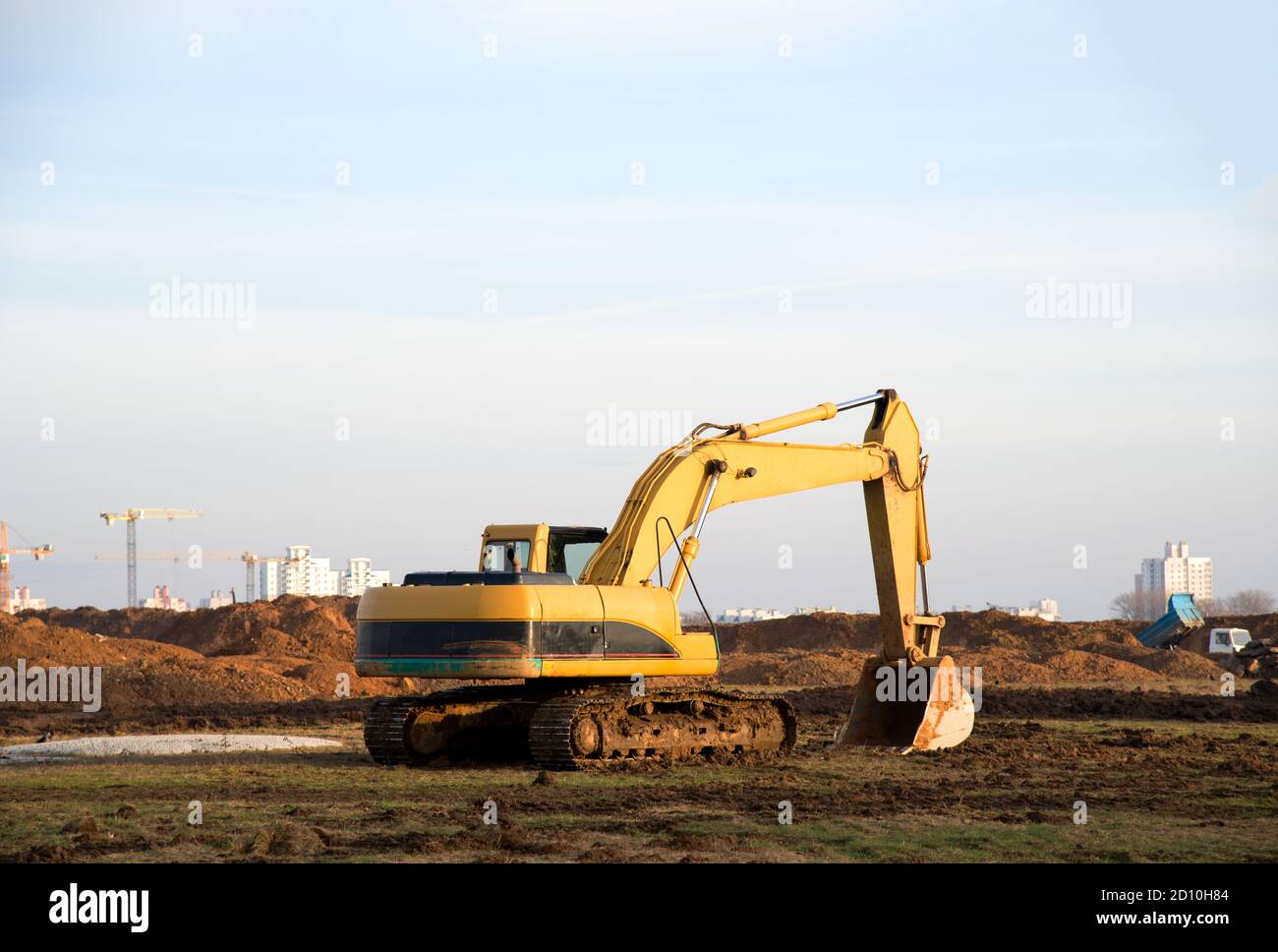 Excavator with a large iron bucket on a construction site during road ...