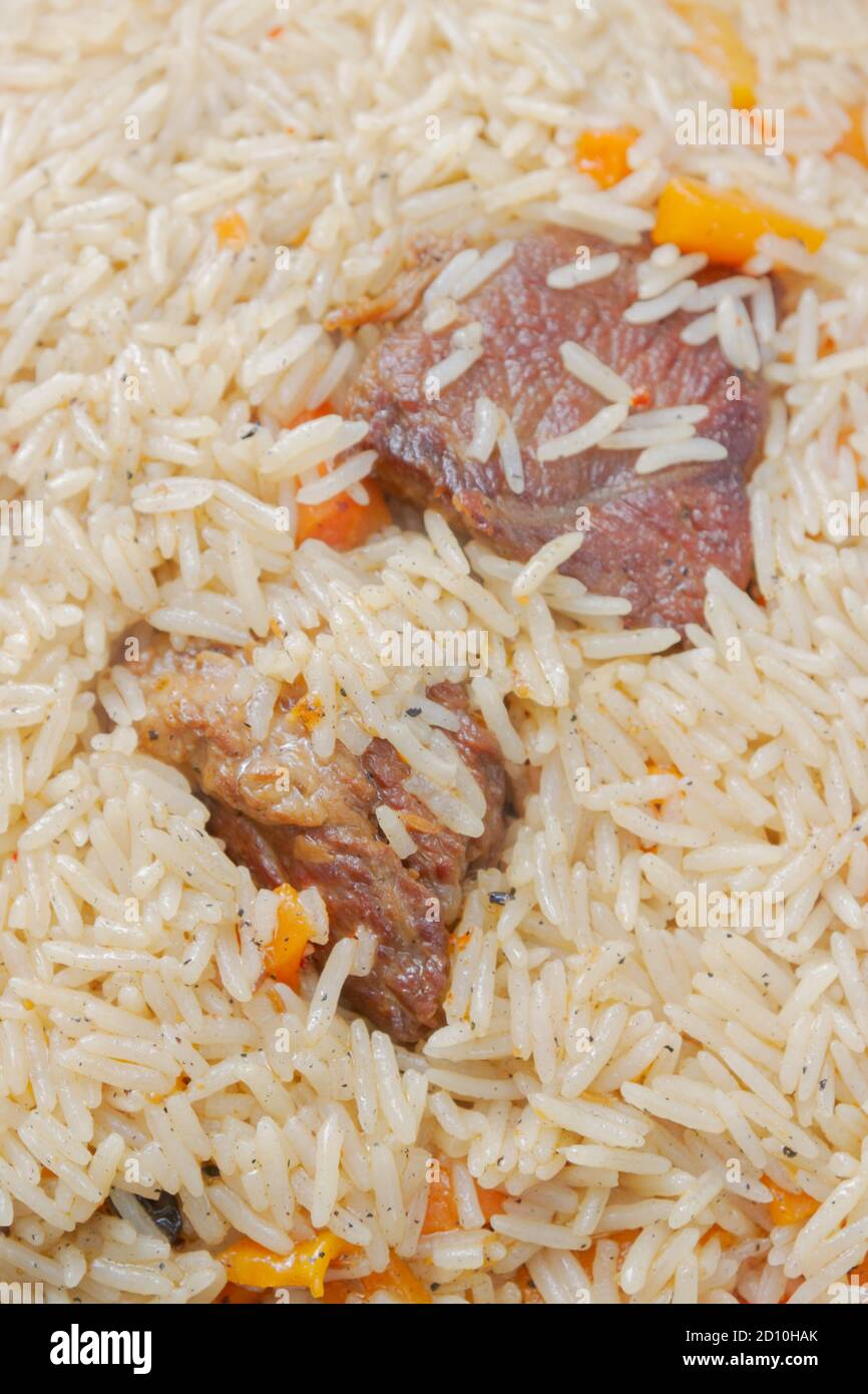 Cooking pilaf in a cauldron on the grill outside in the summer Stock ...