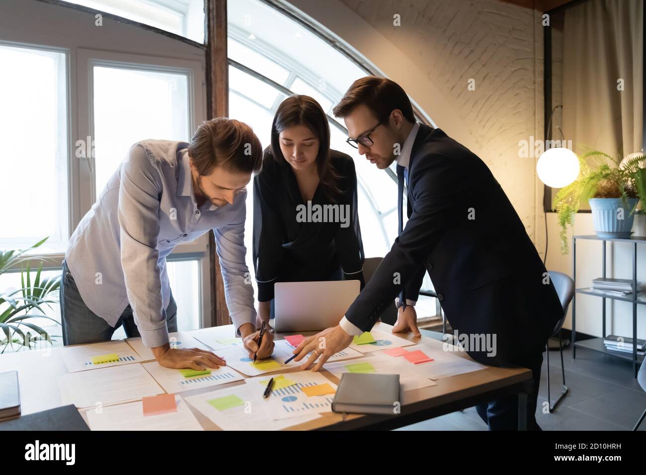 Focused male team leader managing working process with colleagues Stock ...
