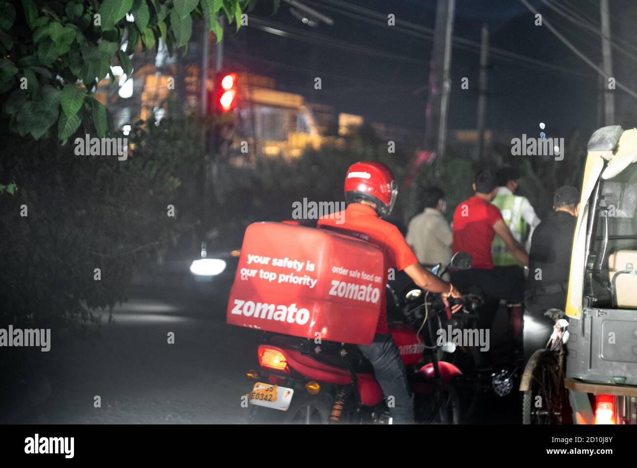 Zomato food delivery rider with red helmet, shirt and food hotbox ...