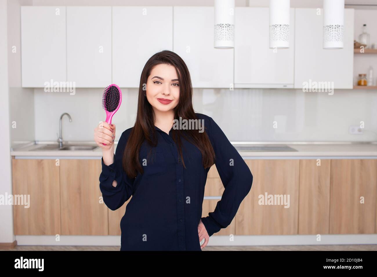 Girl holds a hairbrush without hair and smiling Stock Photo - Alamy