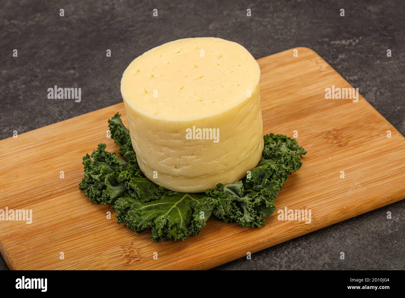 Yellow round dairy soft cheese piece Stock Photo - Alamy