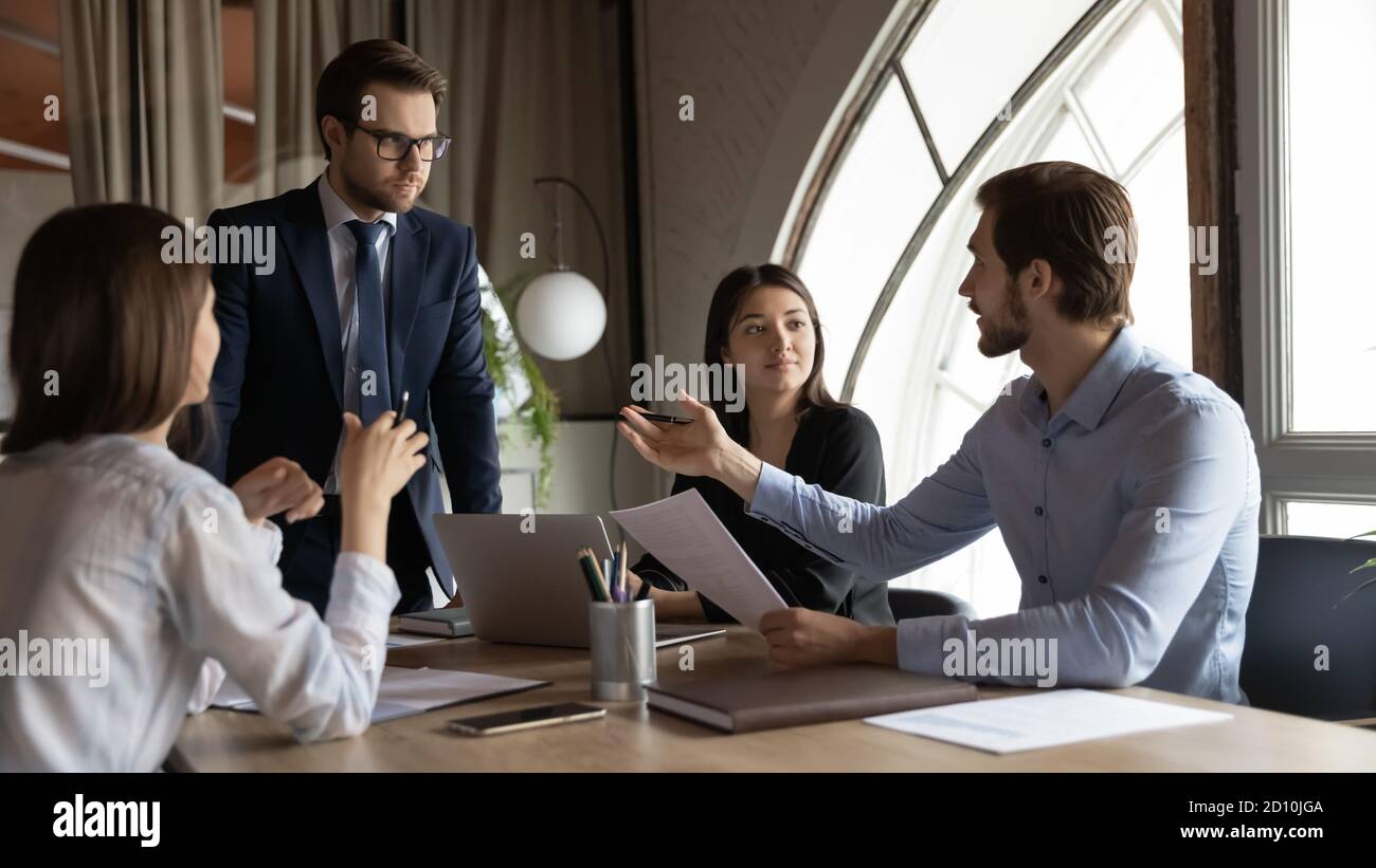 Focused young team leader holding brainstorming meeting in office Stock ...