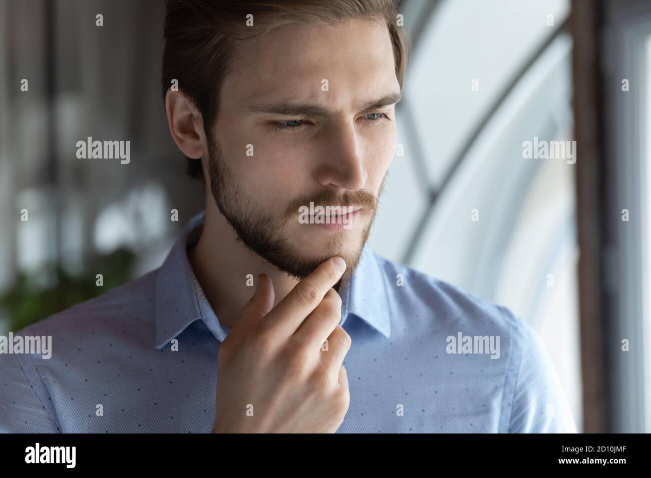 Thoughtful young businessman making difficult choice in office Stock ... Thoughtful young businessman making difficult choice in office Stock ...