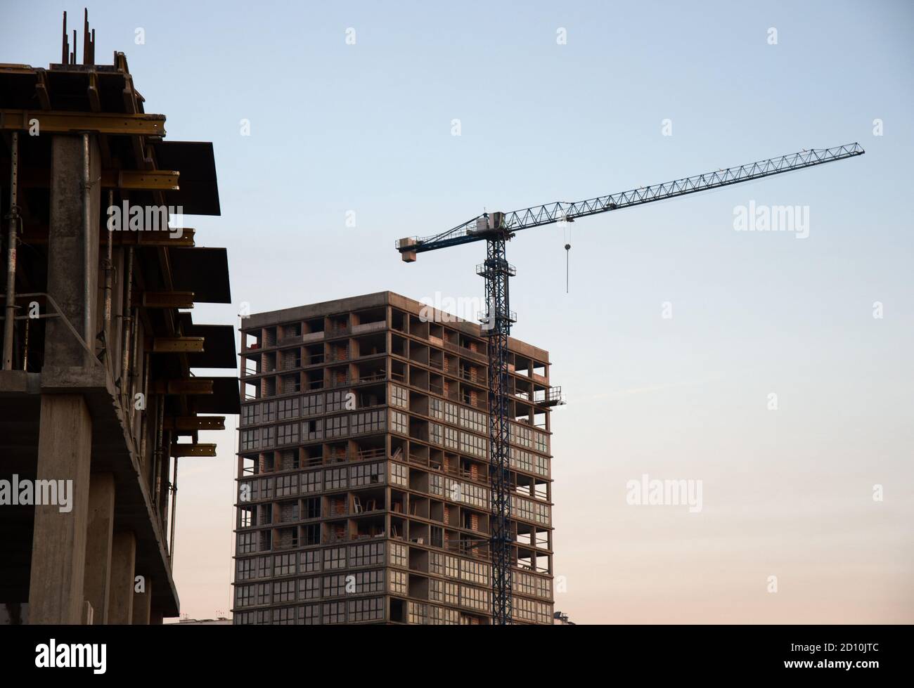 Hydraulic luffing jib tower cranes and workers being poured concrete ...
