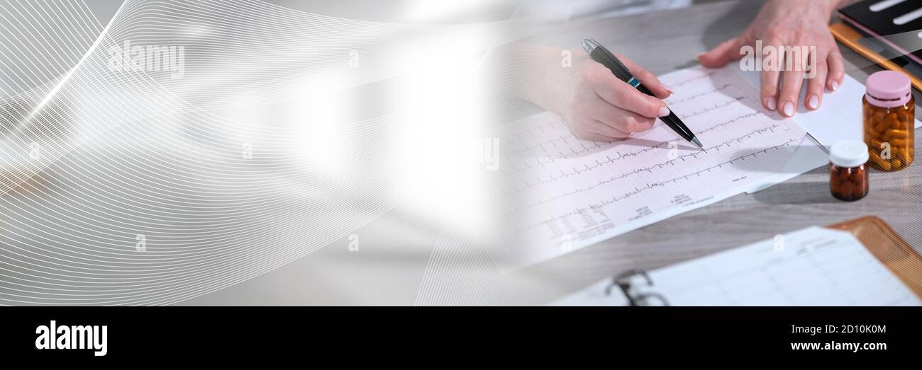 Female cardiologist examining an ecg graph in medical office; panoramic ...