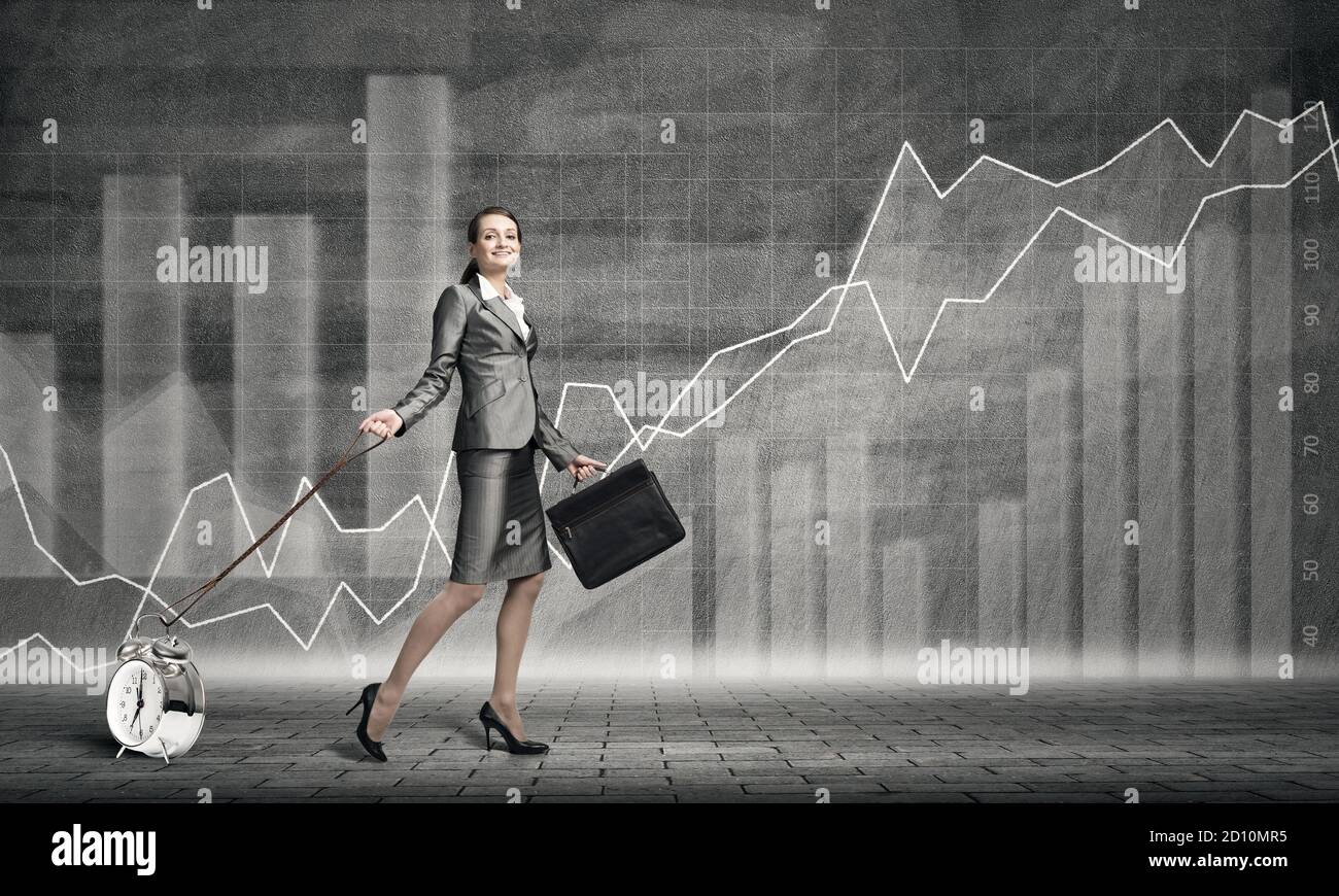 Woman controlling time Stock Photo - Alamy