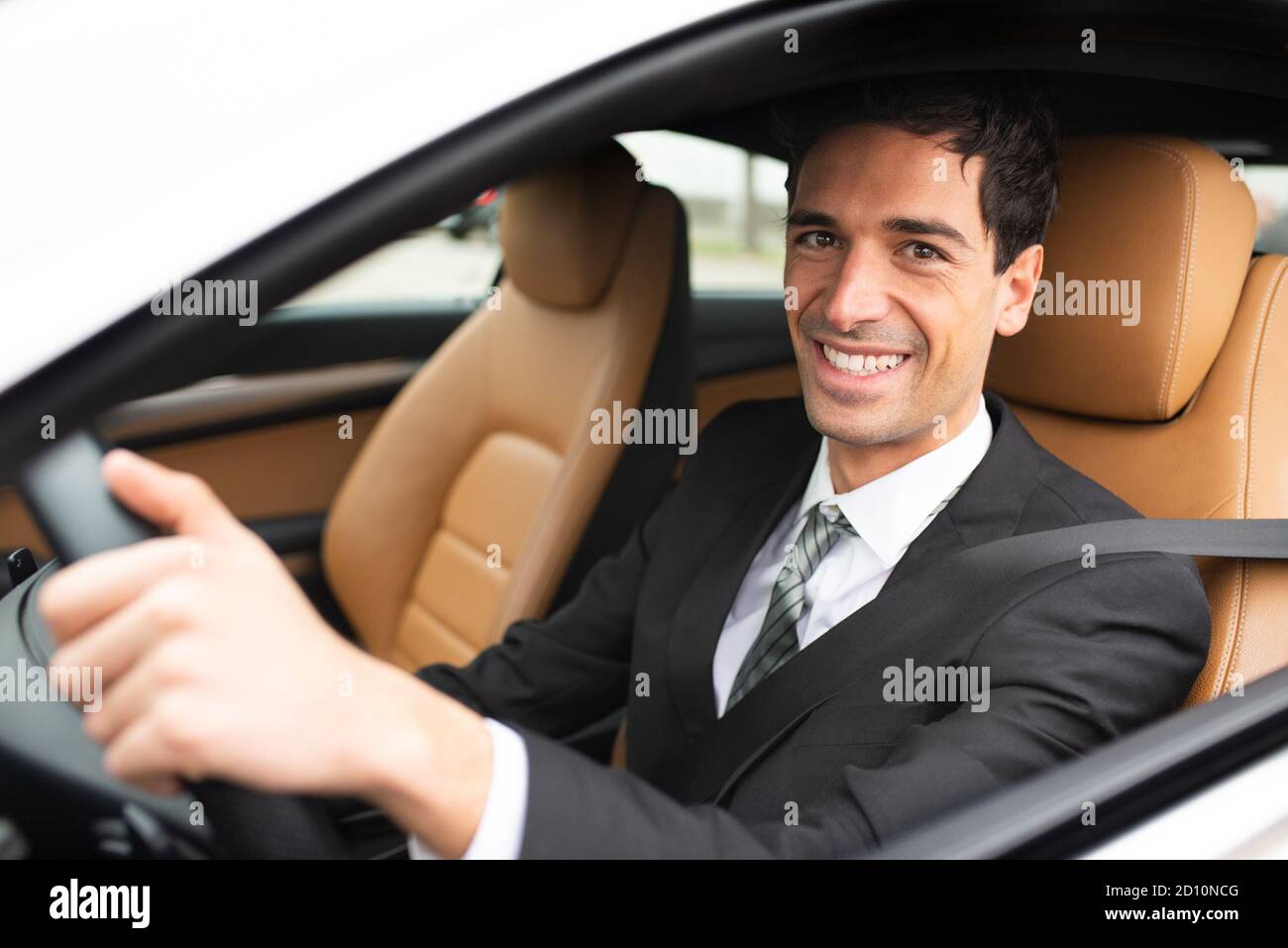 Smiling business man driving his new white car Stock Photo - Alamy