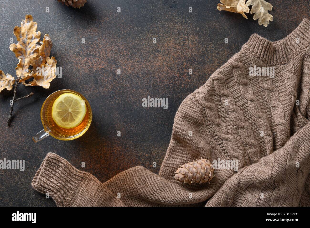 Warming tea with lemon in cozy lifestyle with fall leaves and cozy ...