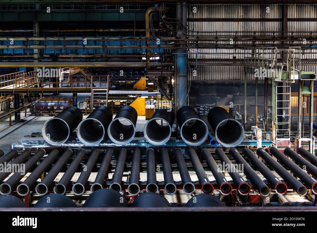 New cast iron pipes for pipeline construction in warehouse Stock Photo ...
