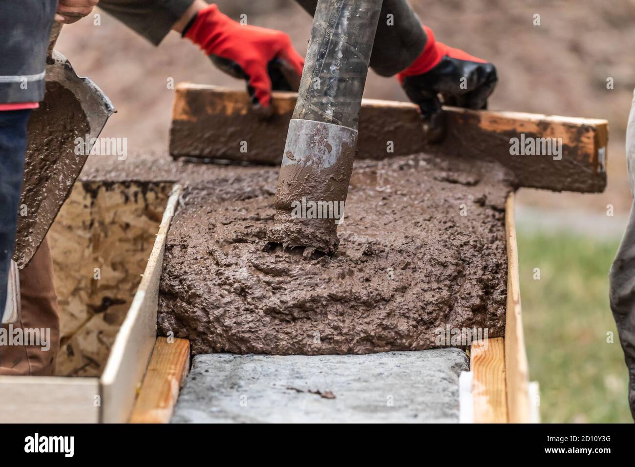 Construction Worker Leveling Wet Cement Into Wood Framing Stock Photo ...