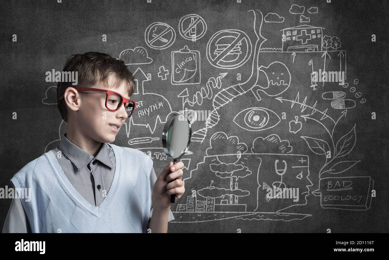 Curious school boy with magnifier Stock Photo - Alamy