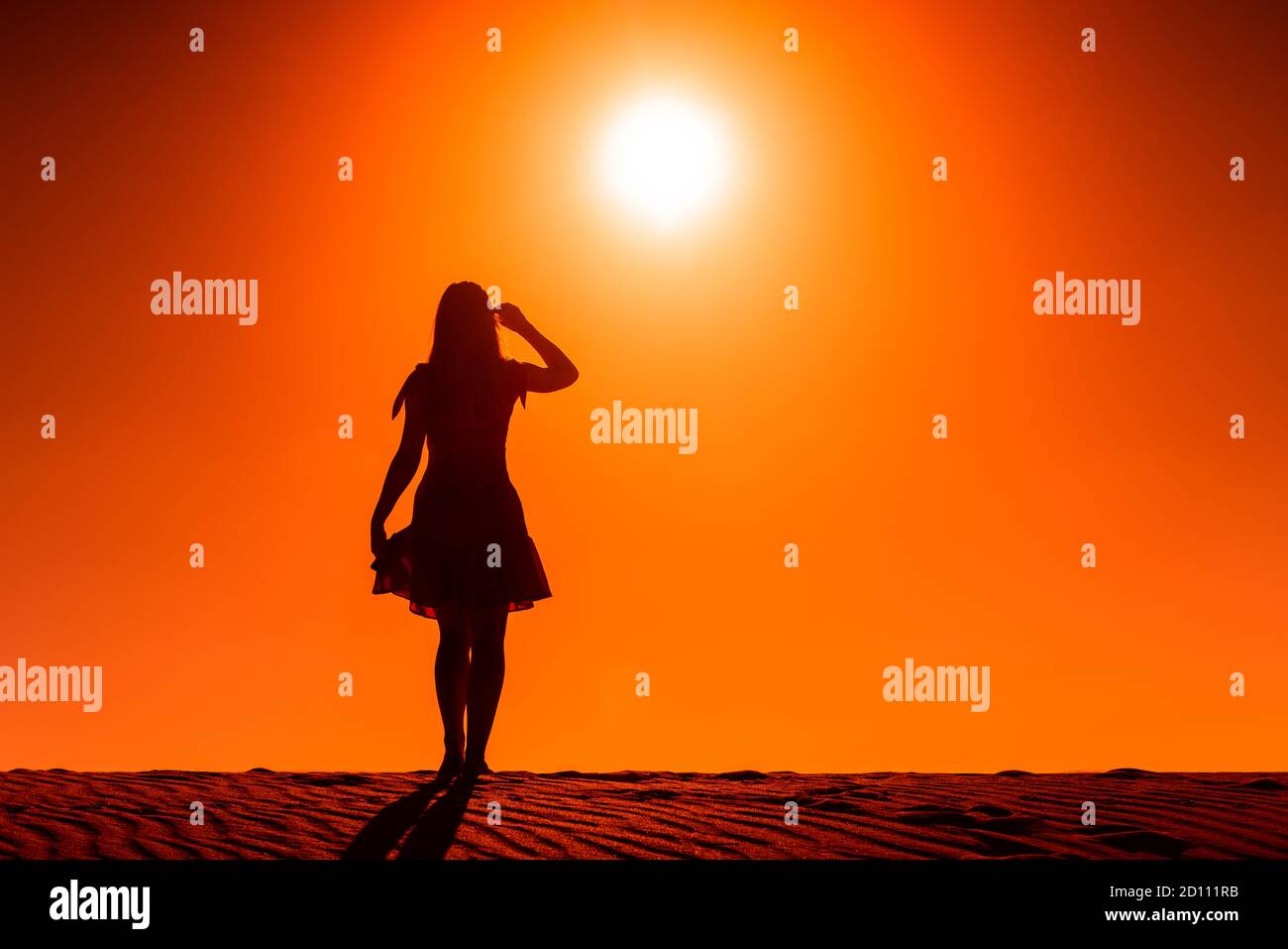 Sun burning mercilessly on a woman standing in a desert Stock Photo - Alamy