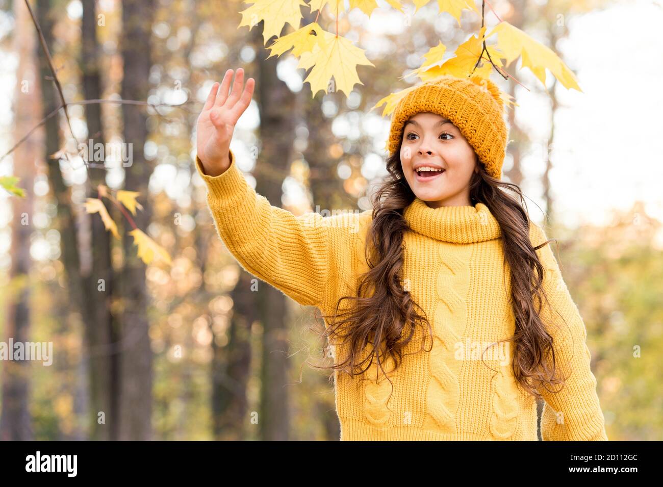 cheerful girl in autumn style waving with happy smile, childhood Stock ...