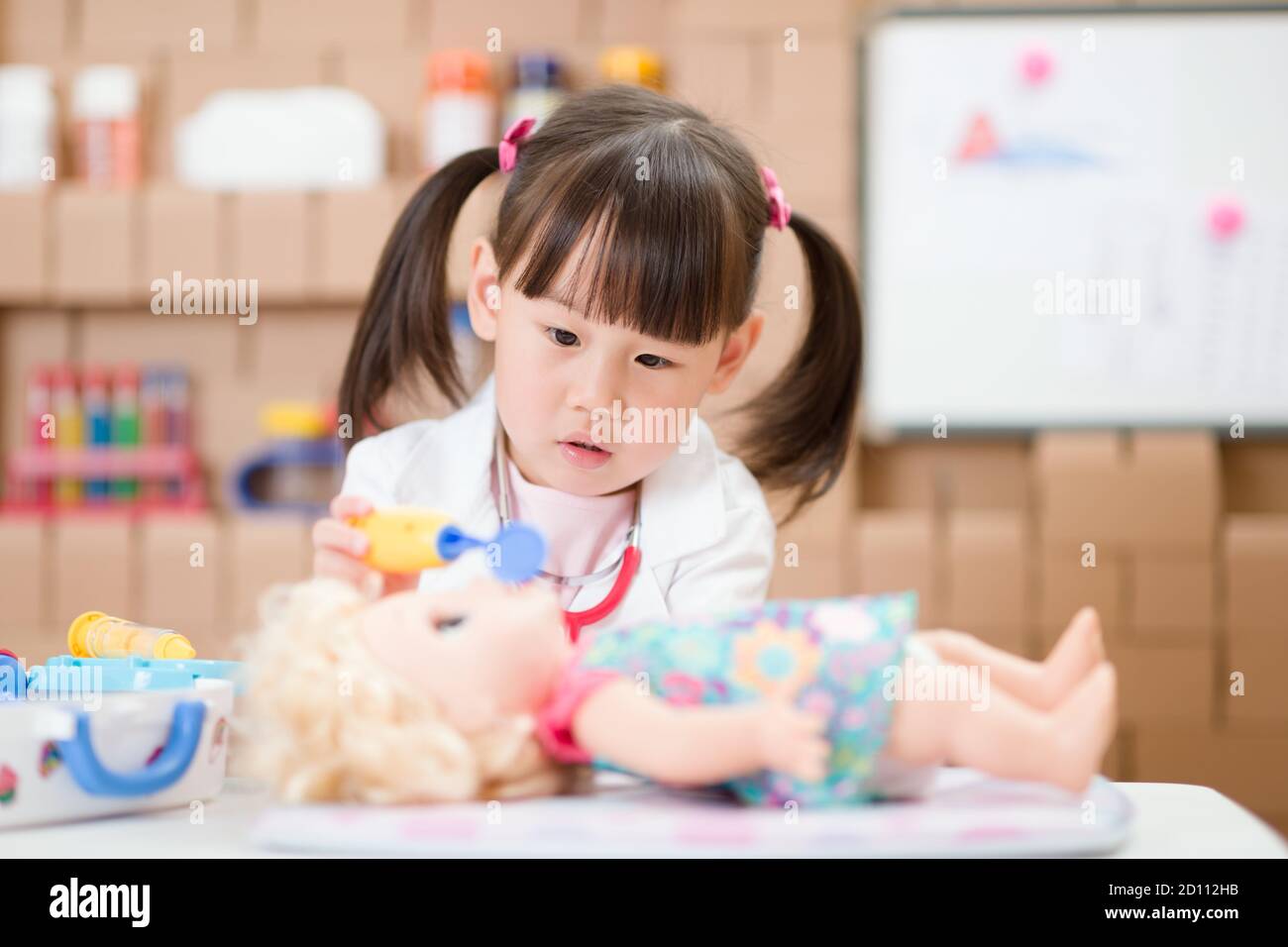 young girl pretend play doctor role at home Stock Photo - Alamy