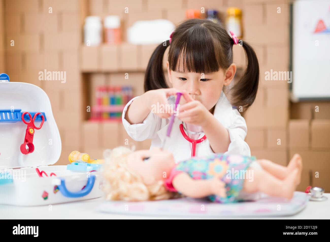 young girl pretend play doctor role at home Stock Photo - Alamy