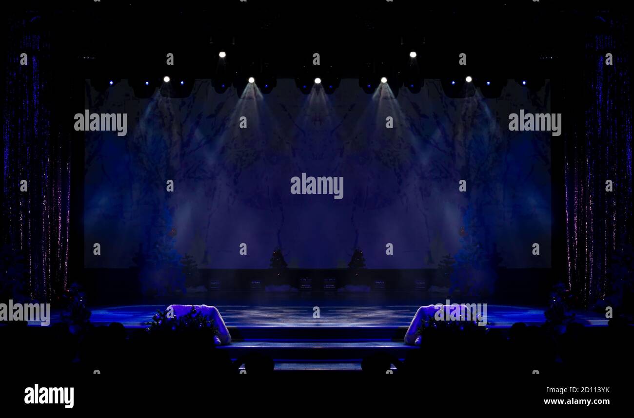 An empty stage of the theater, lit by spotlights and smoke before the ...