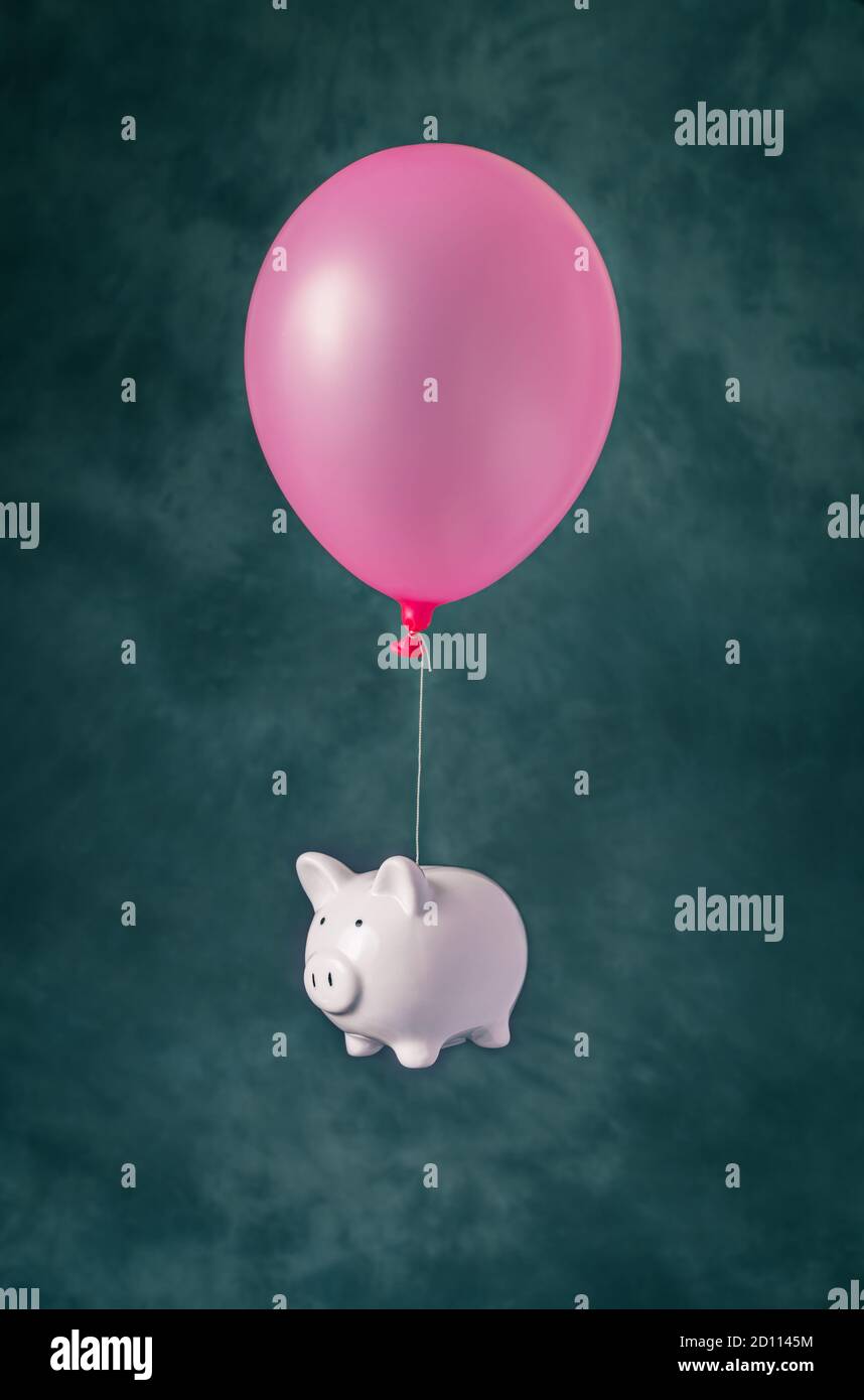 Piggy bank flying on balloon Stock Photo - Alamy