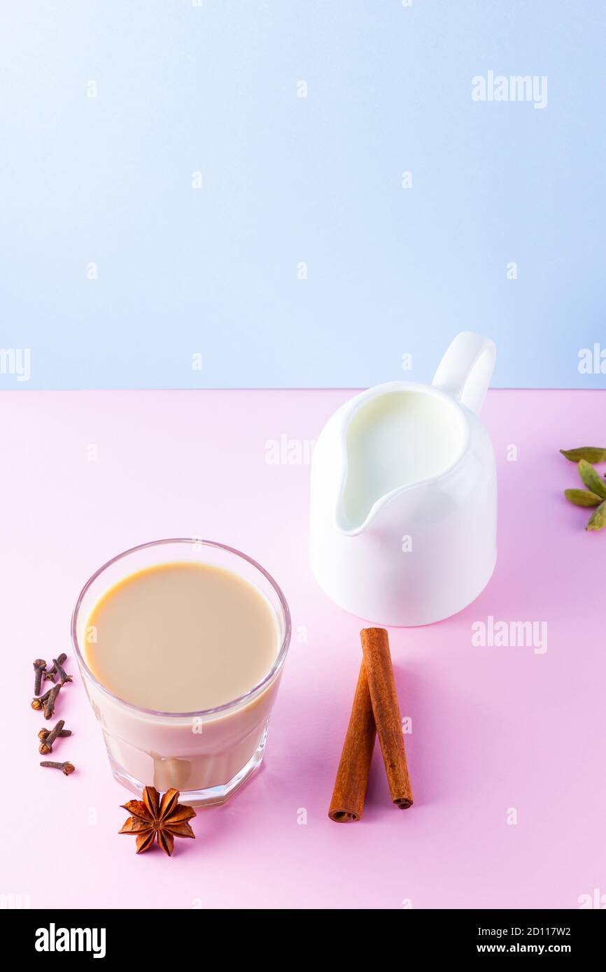 Masala tea and spices on a pink blue background. Masala chai in glass ...