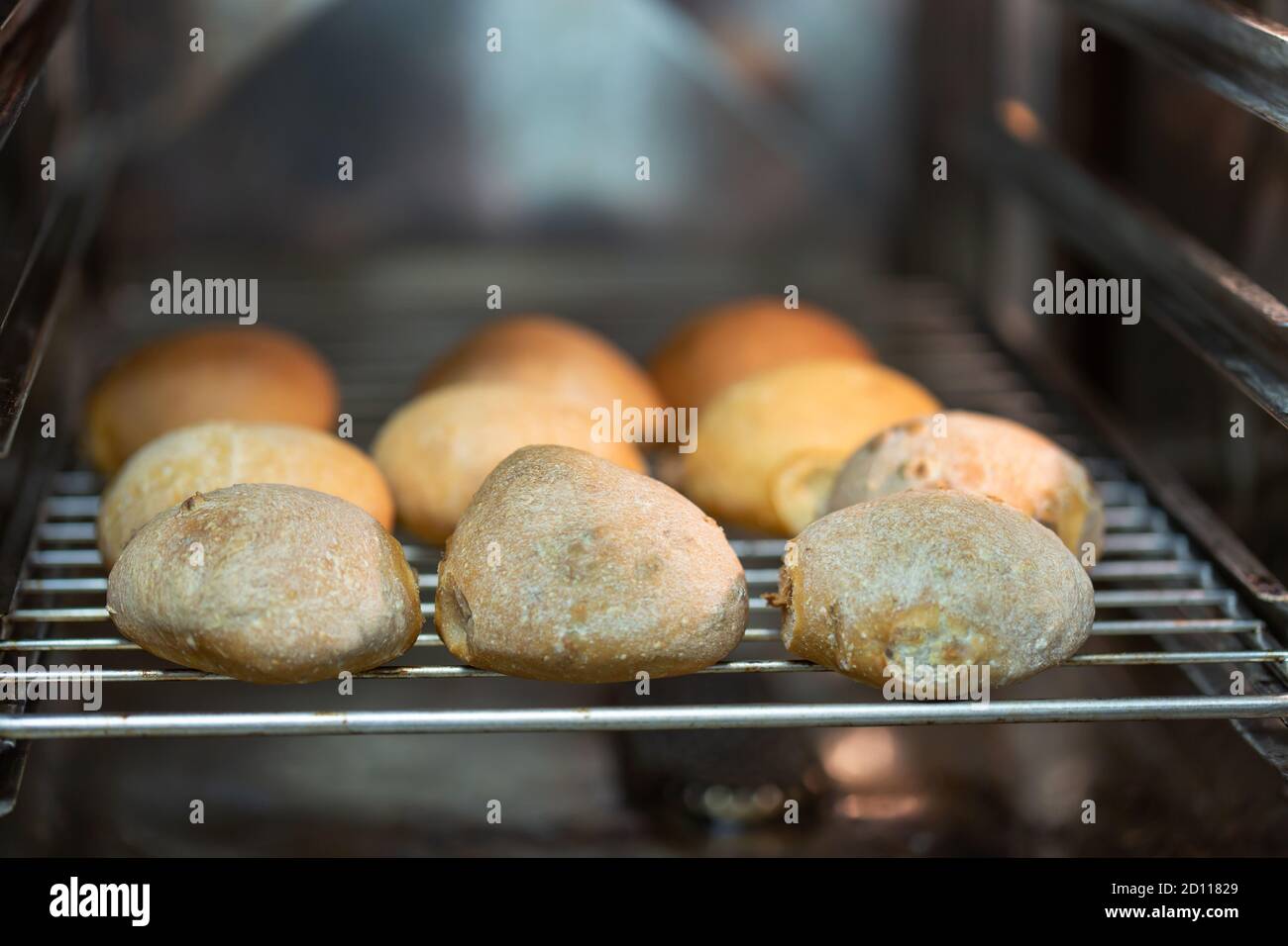 Bread rolls being cooked in a hot oven Stock Photo - Alamy