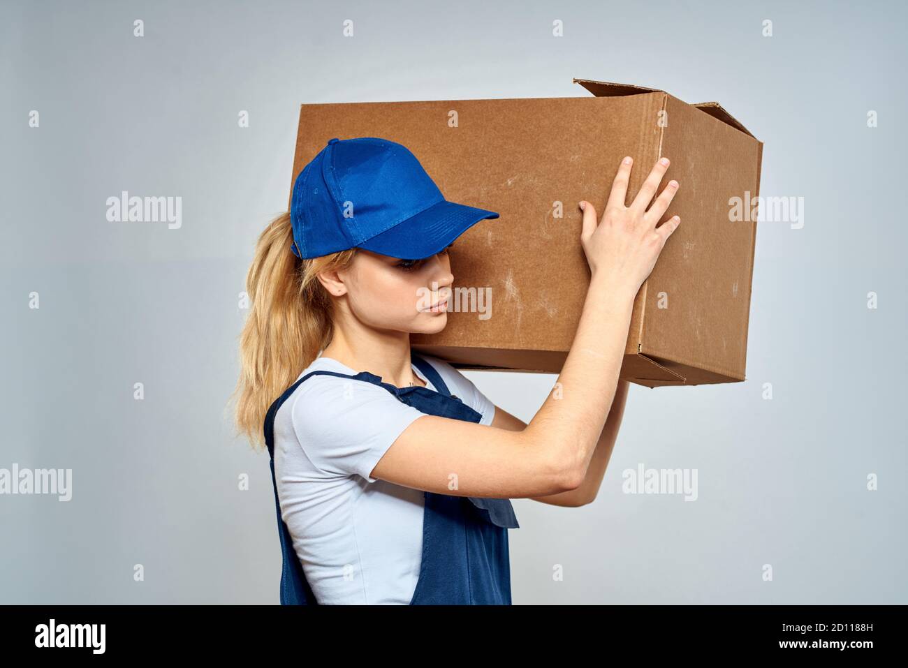 Woman in working uniform box packing service lifestyle Stock Photo - Alamy