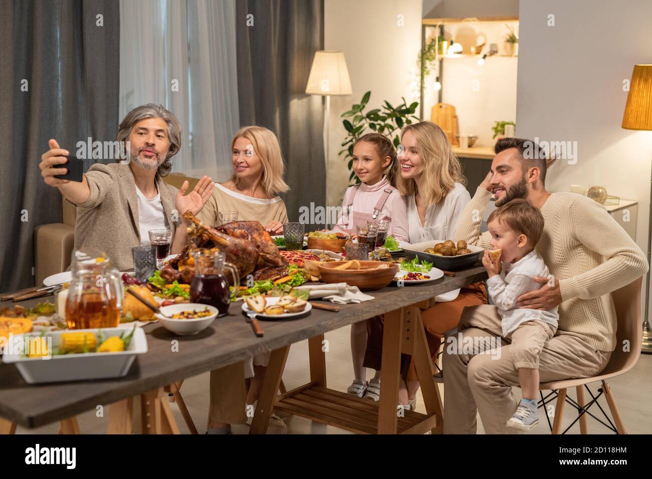 Happy family of three generations making selfie while sitting by ...