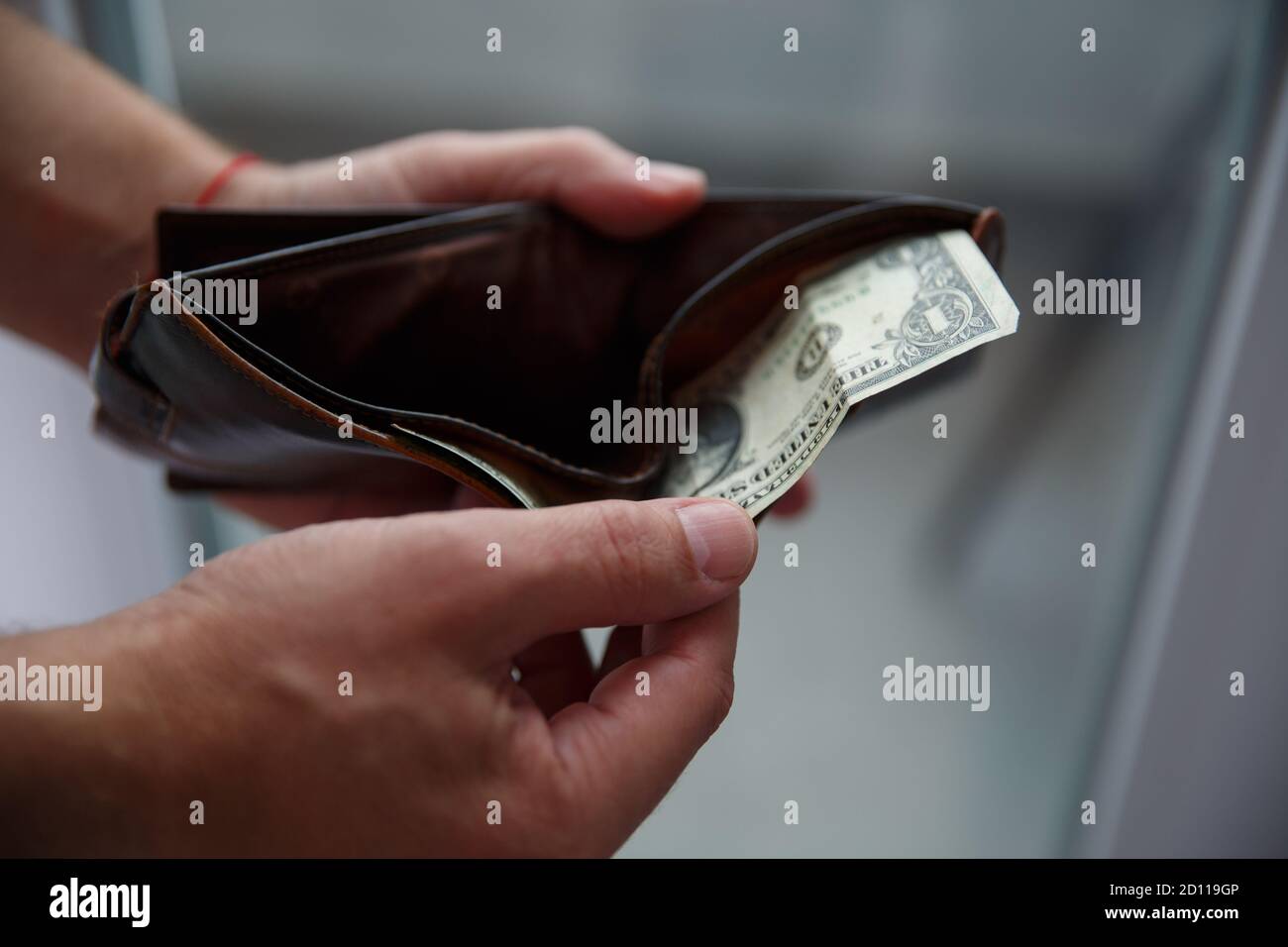 Man's hands pull out a dollar bill from a leather wallet Stock Photo ...