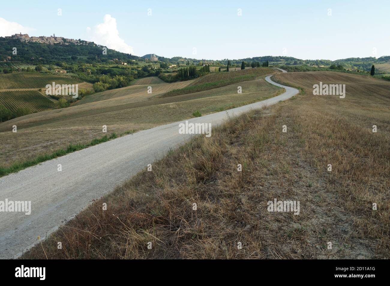 Winding Tuscan "Strada Bianca" road leading to The San Biagio Church of ...