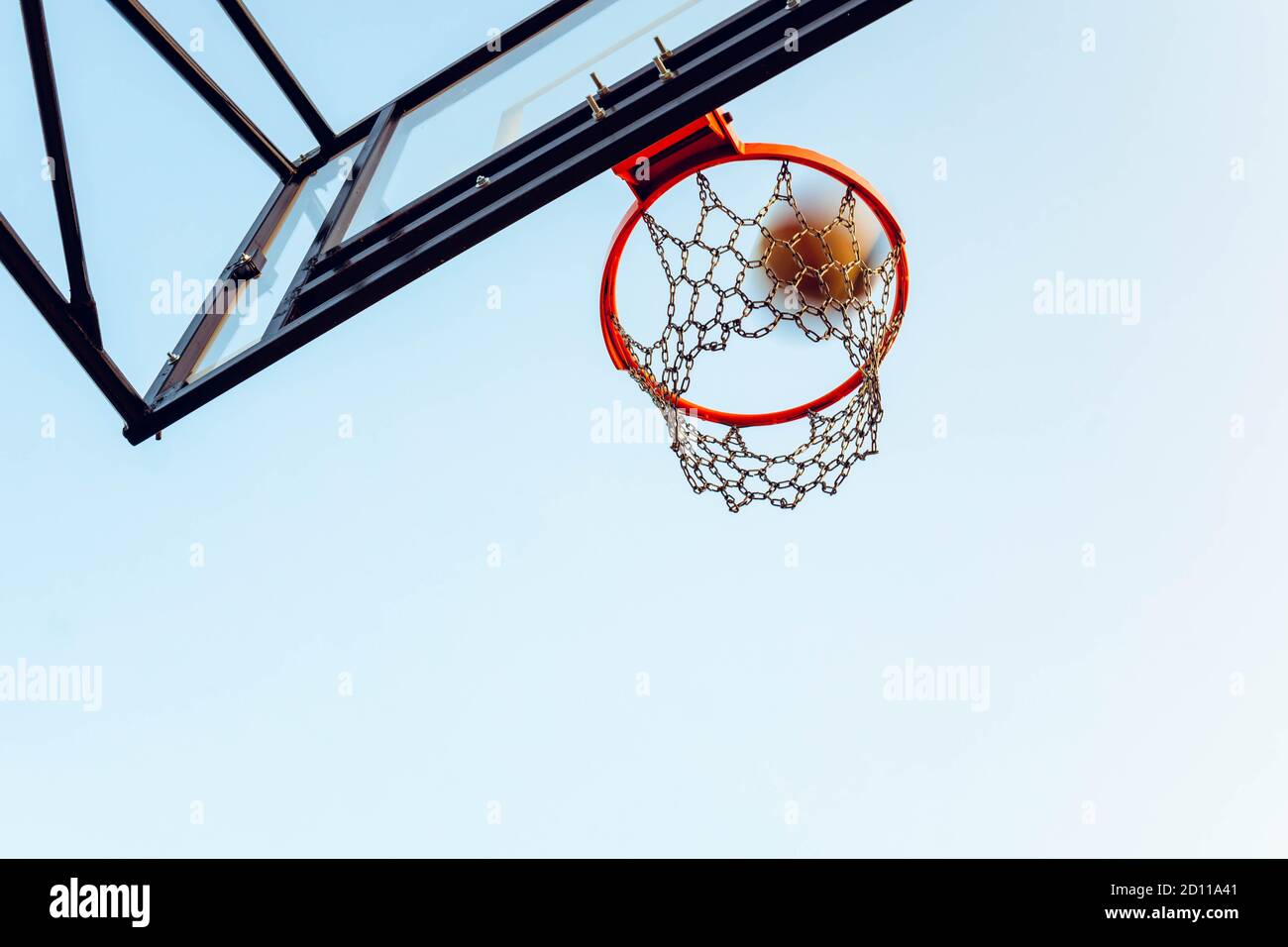 Bottom view of red basketball hoop with ball flying in. Copy space ...