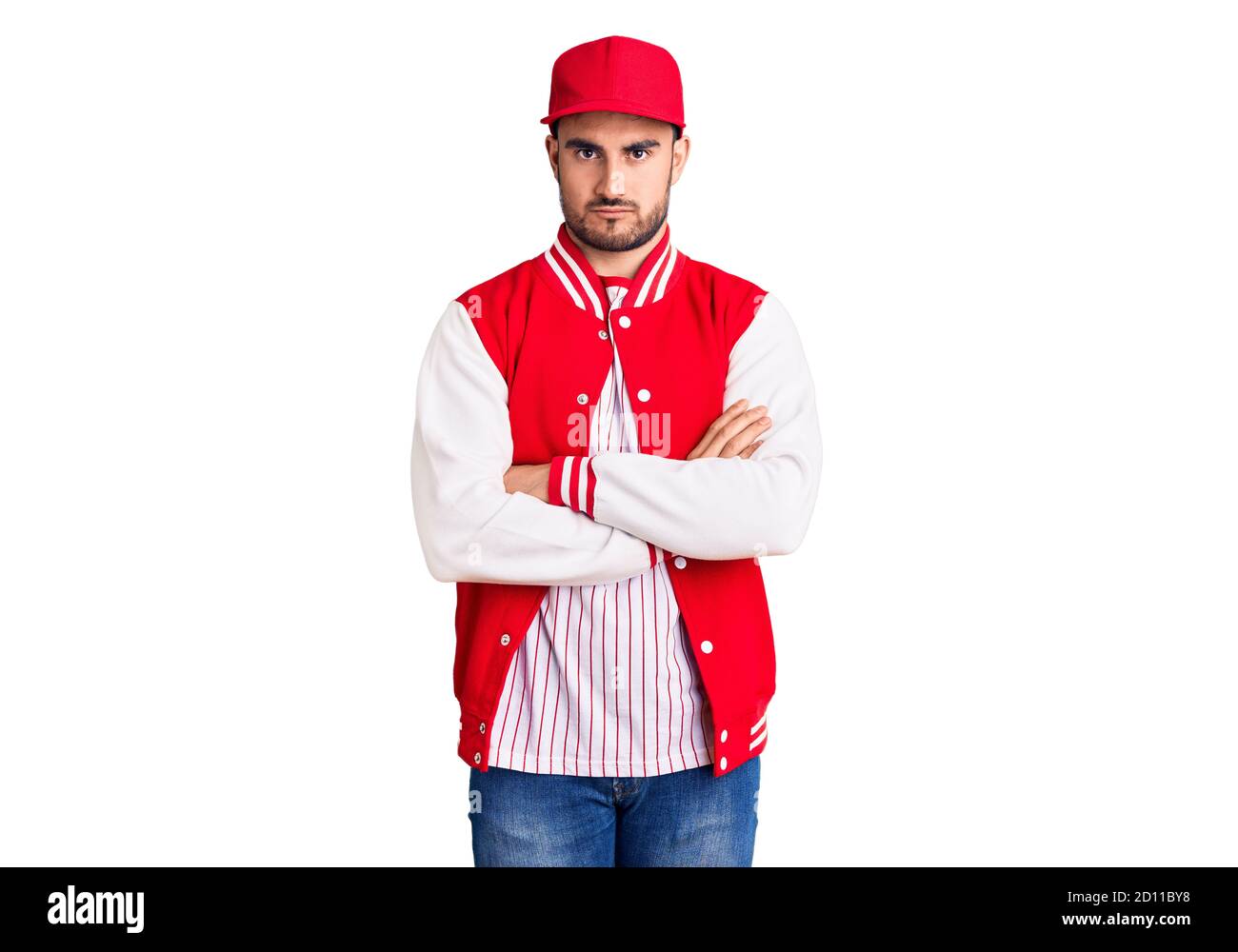 Young handsome man wearing baseball jacket and cap skeptic and nervous ...