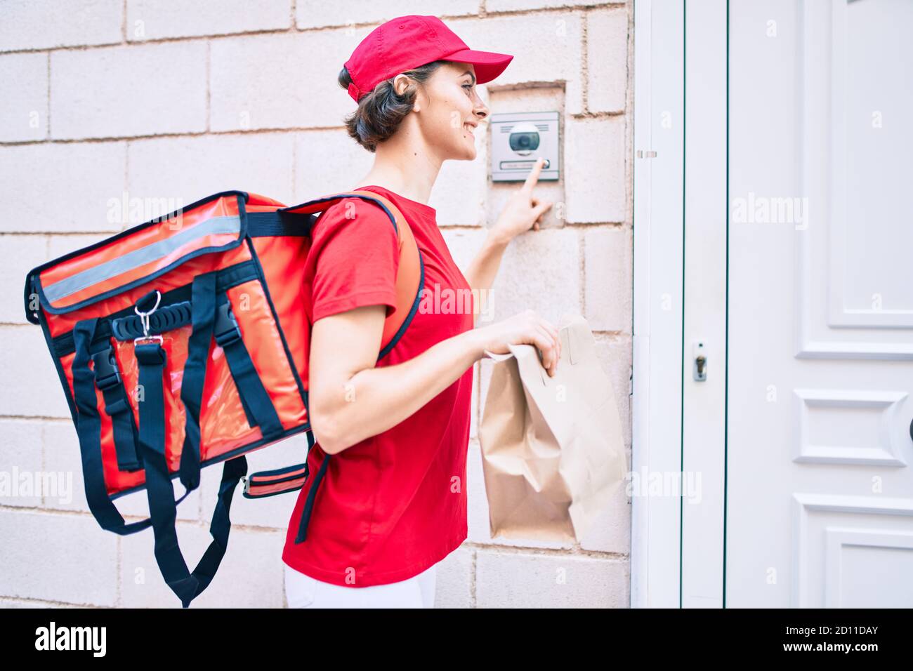 Delivery business worker woman wearing uniform smiling happy knocking ...