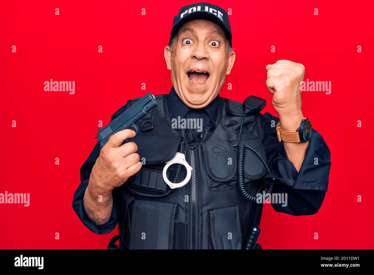 Senior man with grey hair wearing police uniform holding gun screaming ...