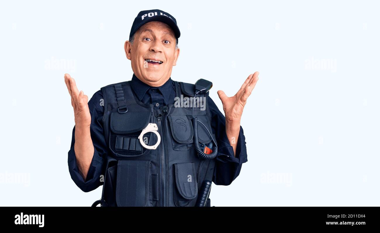 Senior handsome man wearing police uniform celebrating victory with ...