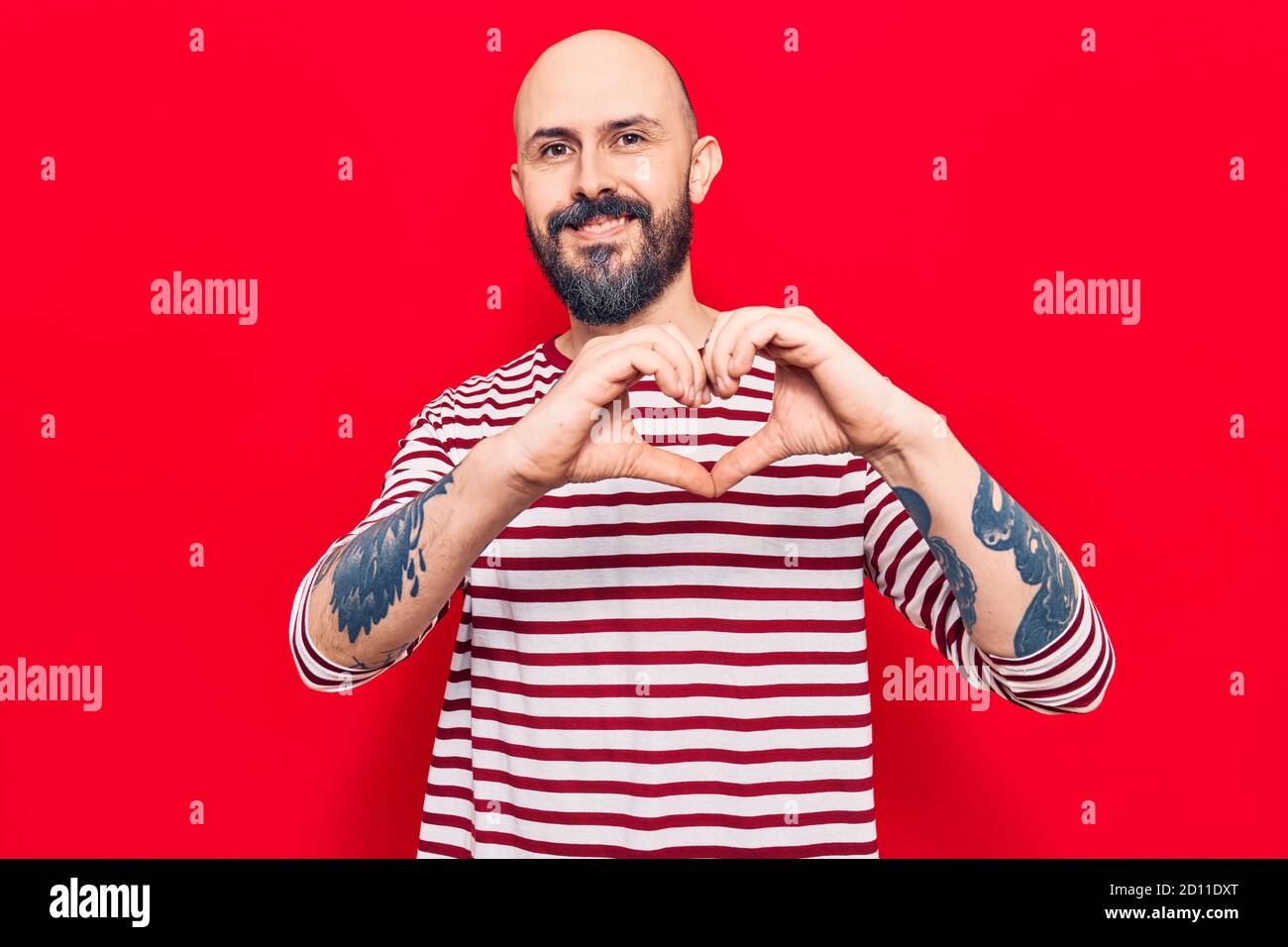 Young handsome man wearing casual clothes smiling in love showing heart ...