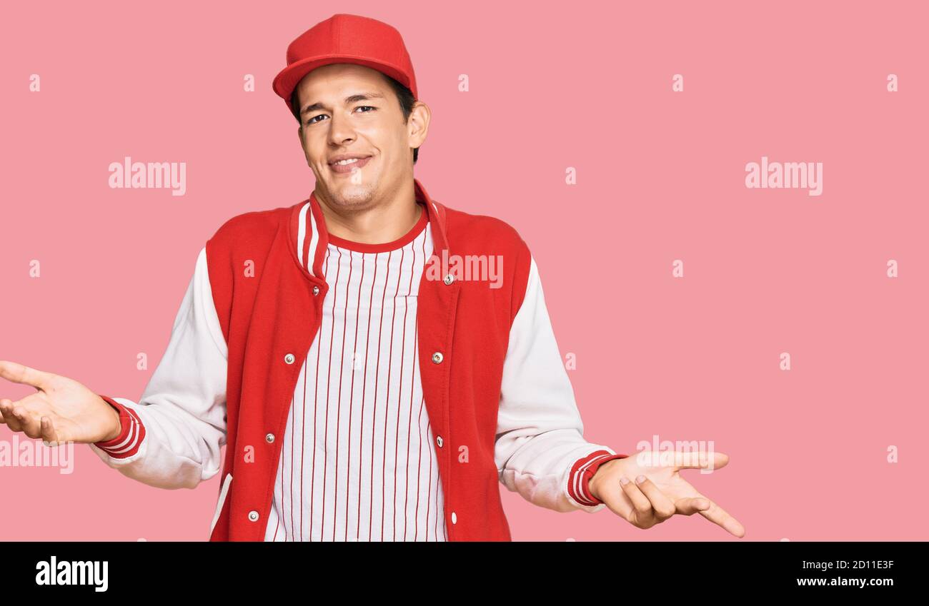 Handsome caucasian man wearing baseball uniform clueless and confused ...