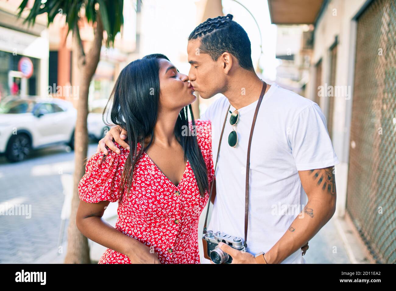 Young latin tourist couple hugging and kissing at street of city Stock ...