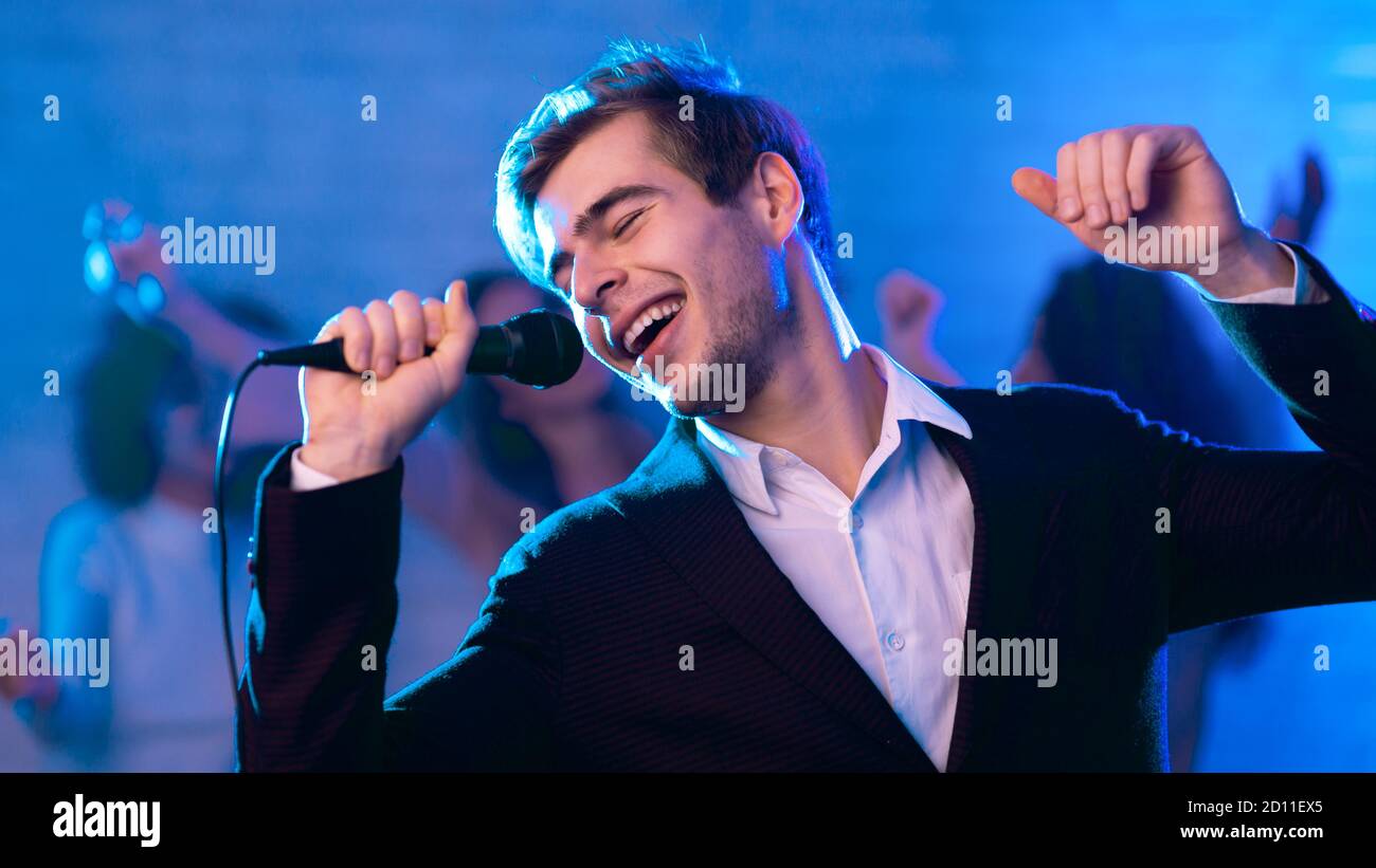Young male microphone stage hi-res stock photography and images - Alamy
