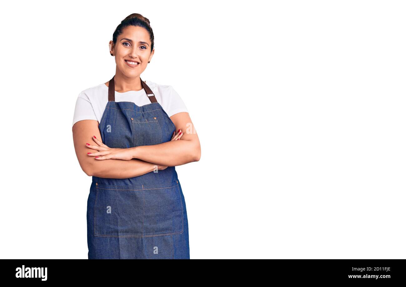 Young beautiful brunette woman wearing apron happy face smiling with ...