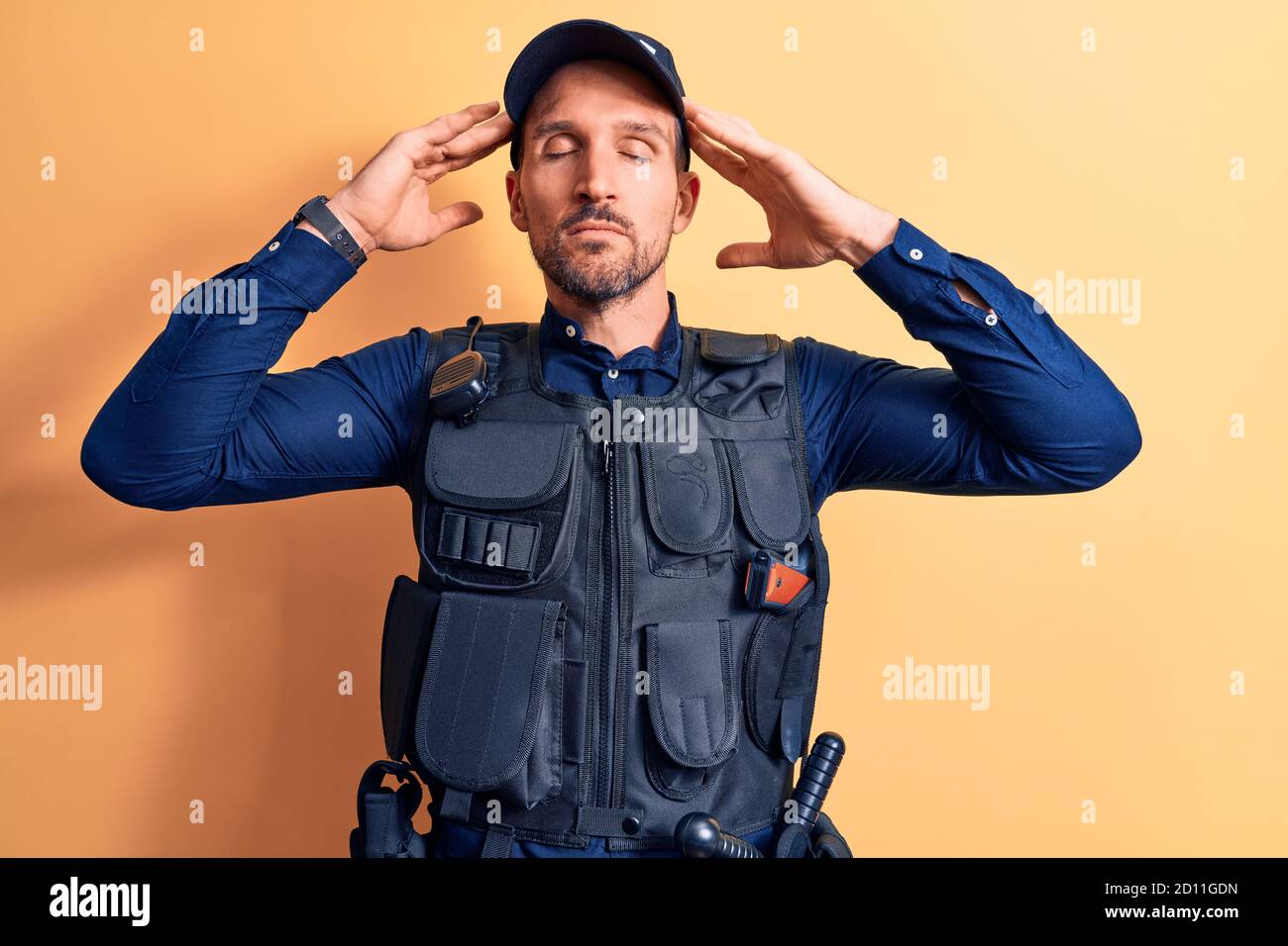 Young handsome policeman wearing police uniform and bulletprof over ...