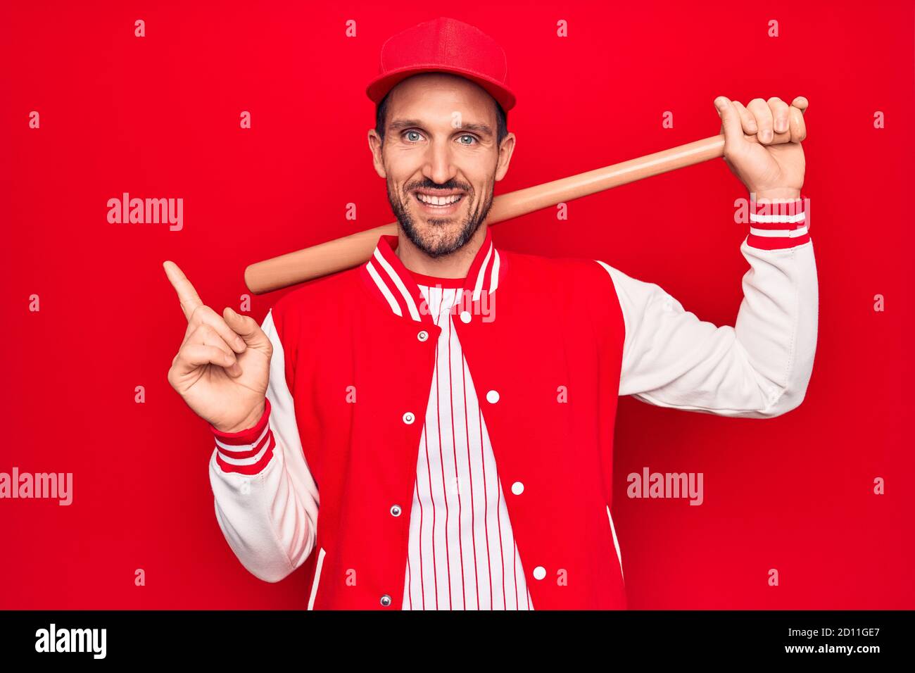 Young handsome player man wearing sportswear playing baseball using bat ...