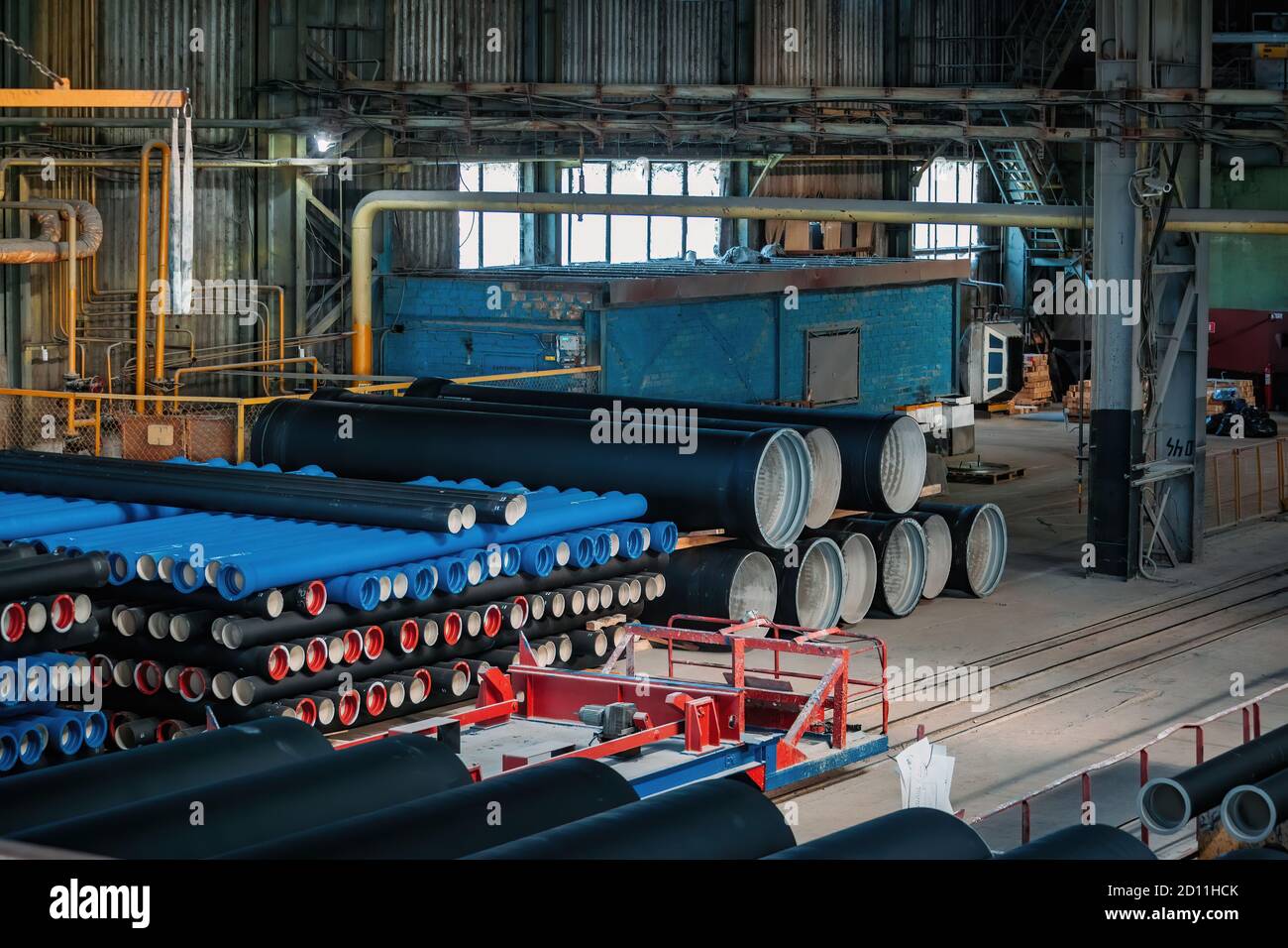 New cast iron pipes for pipeline construction in warehouse Stock Photo ...