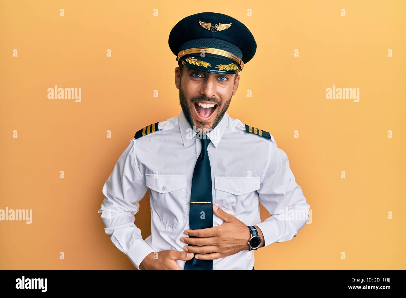 Handsome hispanic man wearing airplane pilot uniform smiling and ...