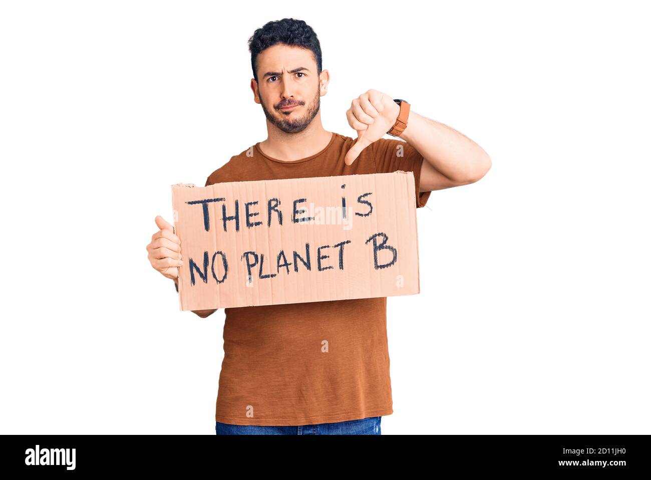 Young hispanic man holding there is no planet b banner with angry face ...