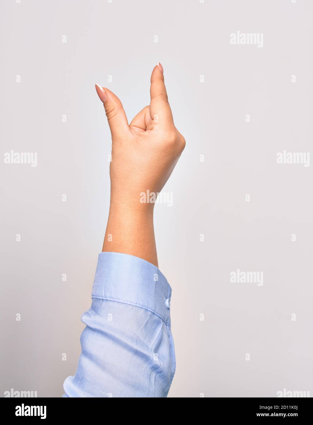 Hand of caucasian young woman doing catch sign over isolated white ...
