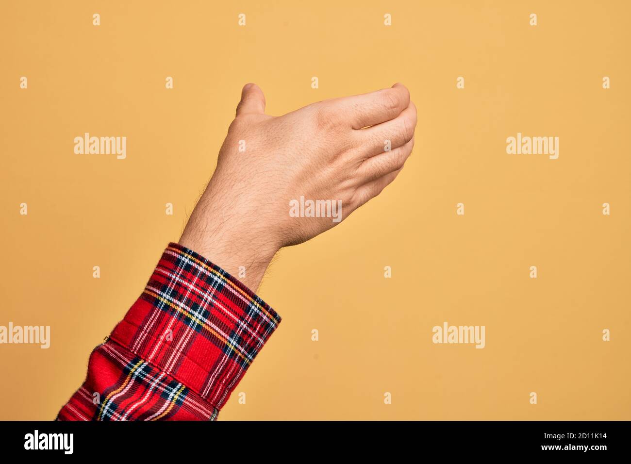 Hand of caucasian young man showing fingers over isolated yellow ...