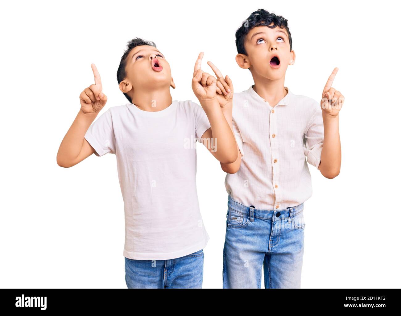 Couple of little brothers together wearing casual clothes amazed and ...