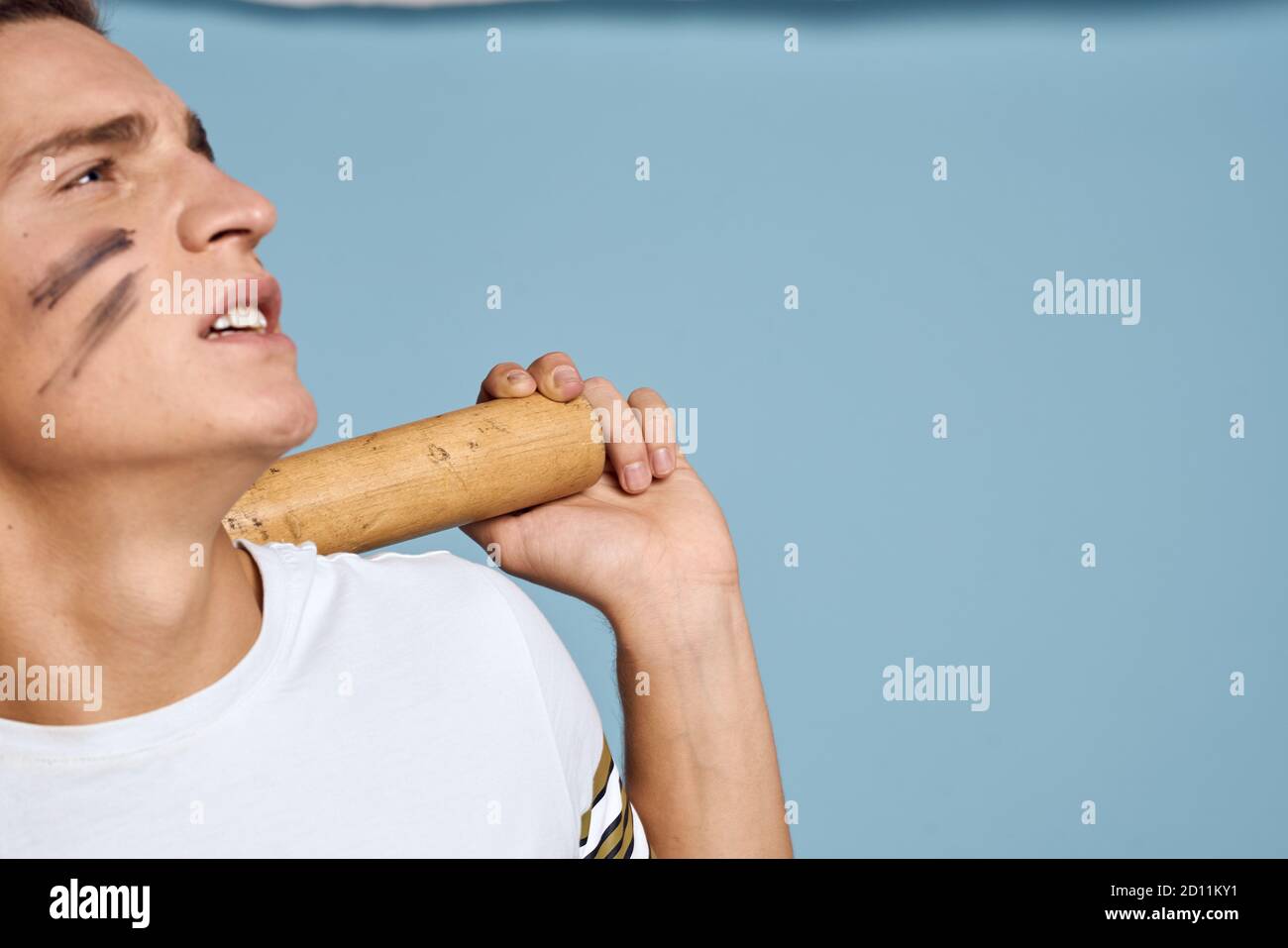 baseball guy with a bat in his hand on a blue background and a combat ...