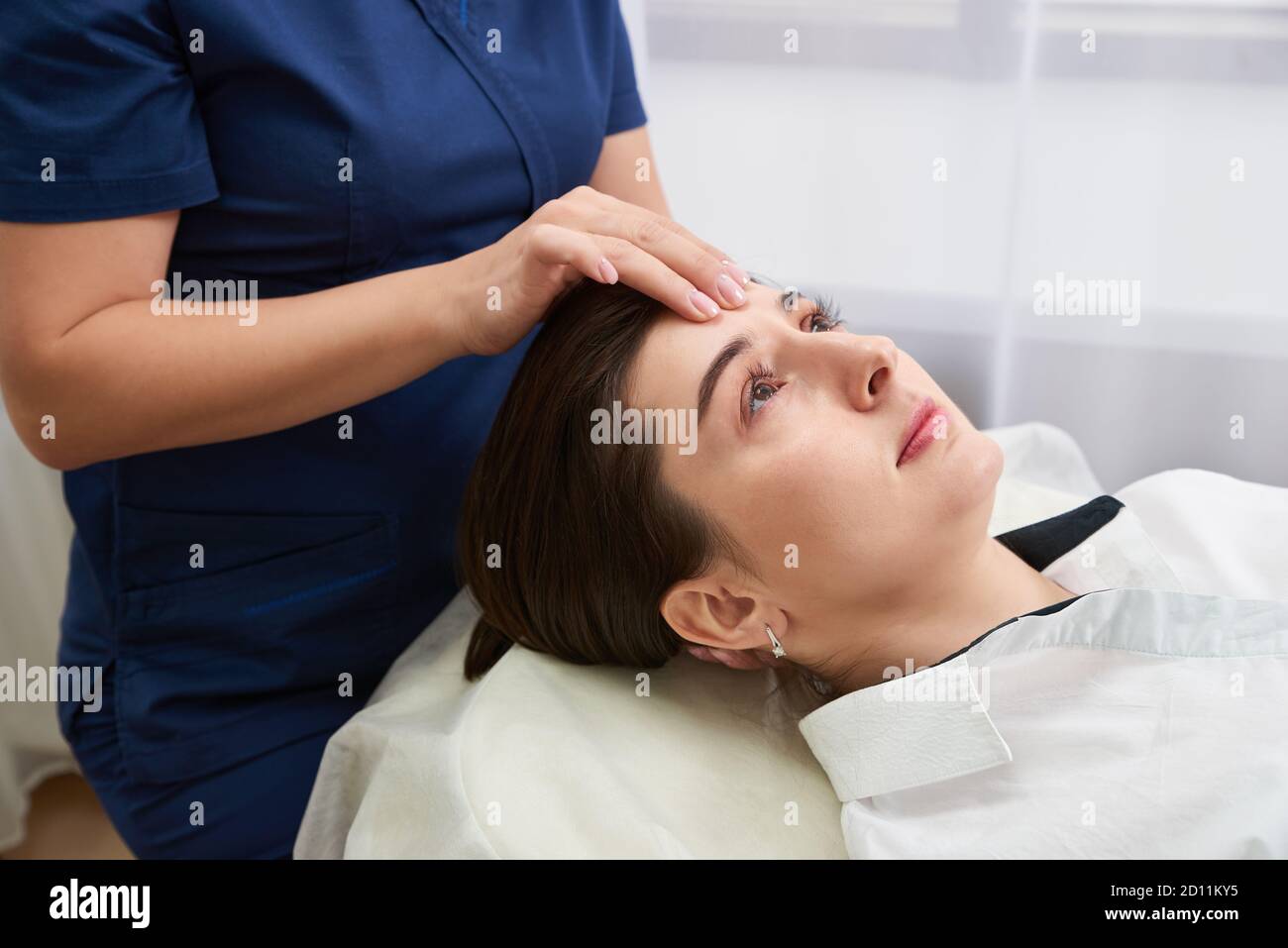 Beautiful Young Woman Getting a Face and head Treatment at Beauty Salon ...